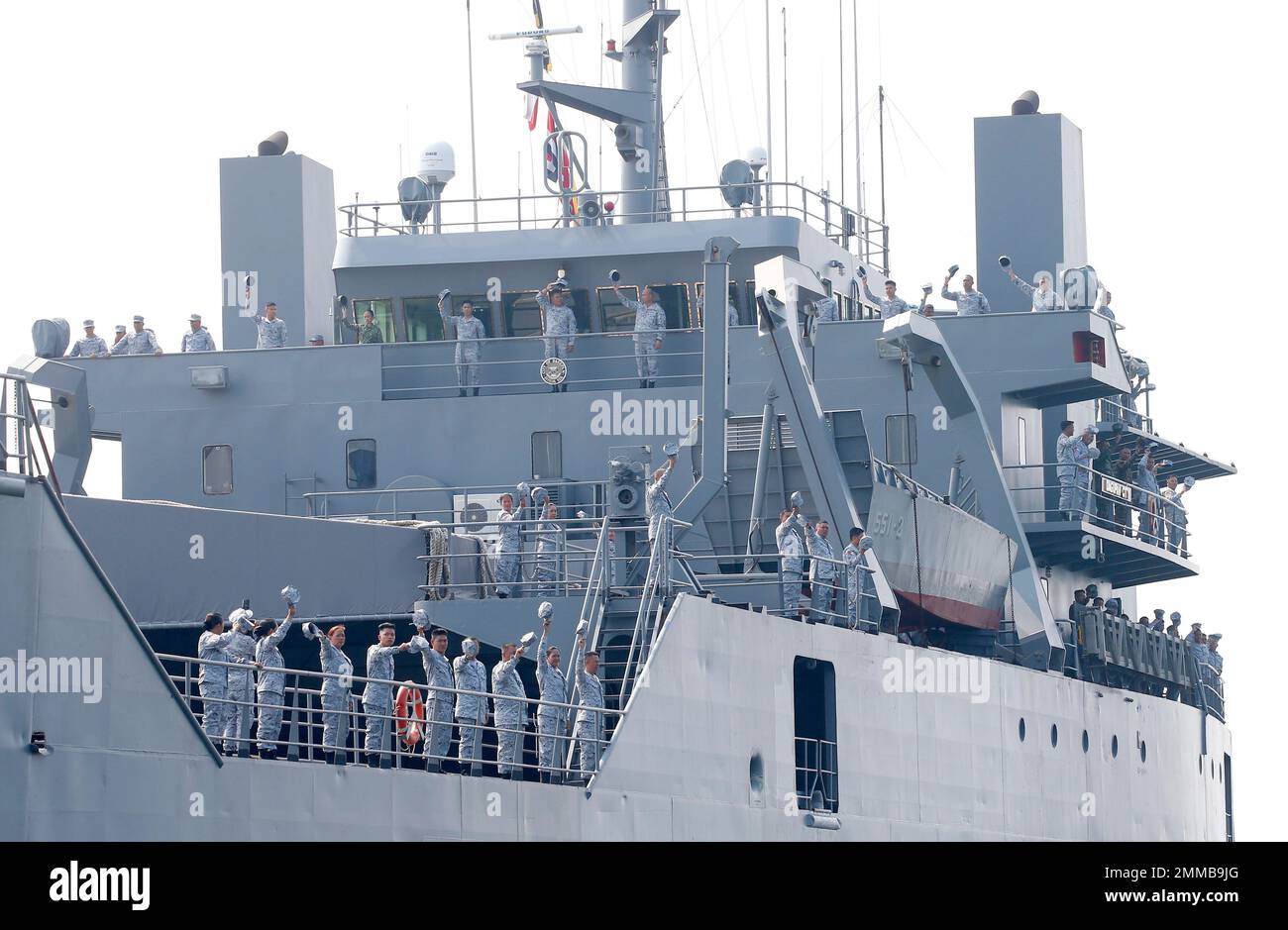 Philippine Navy troops wave from the landing ship BRP Dagupan City ...