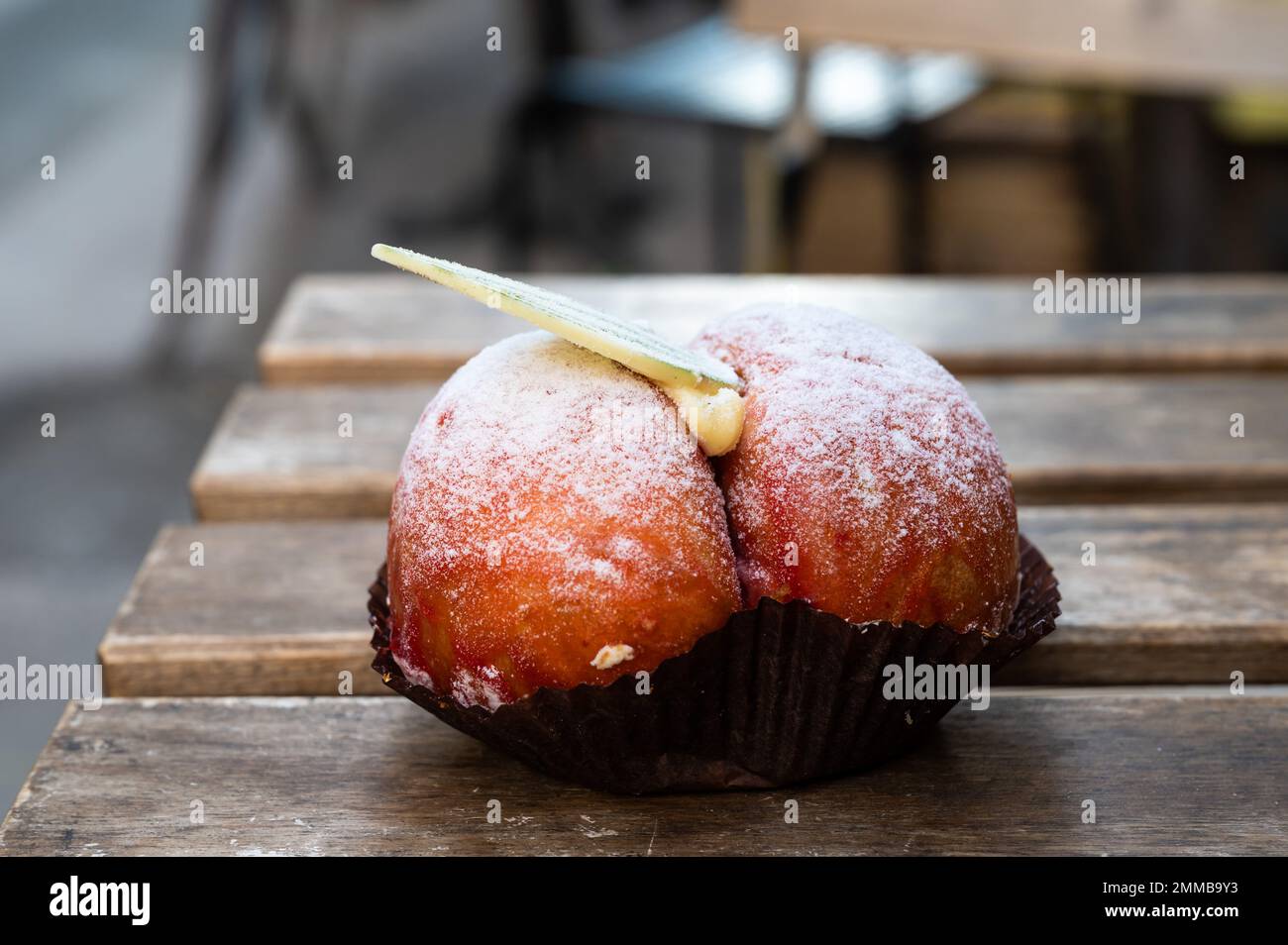 Red pastery with powder sugar and white chocolate filled with custard ...