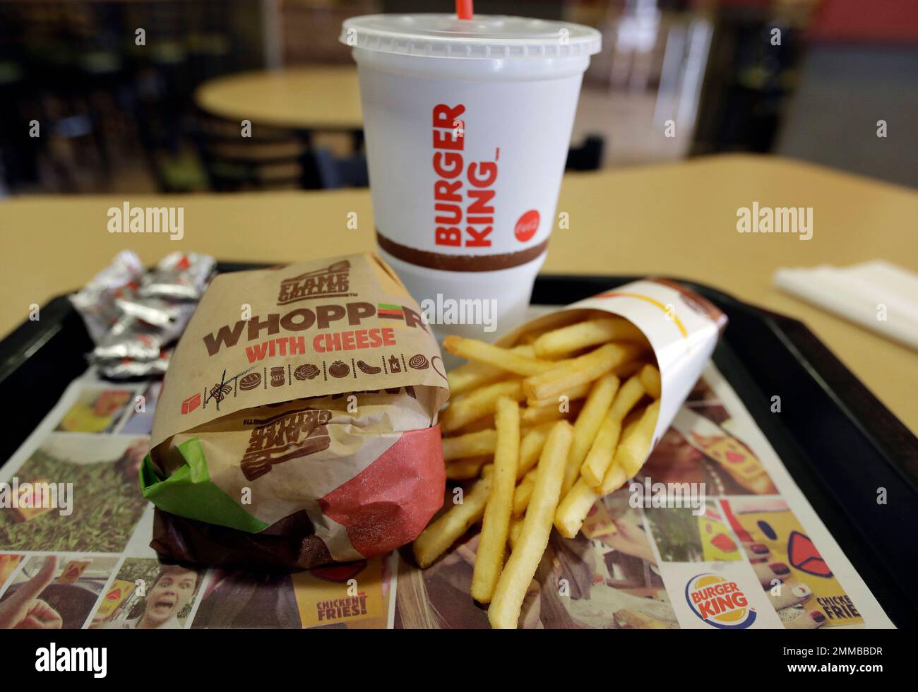 A bacon Whopper with cheese meal sits on a table at a Burger King on ...