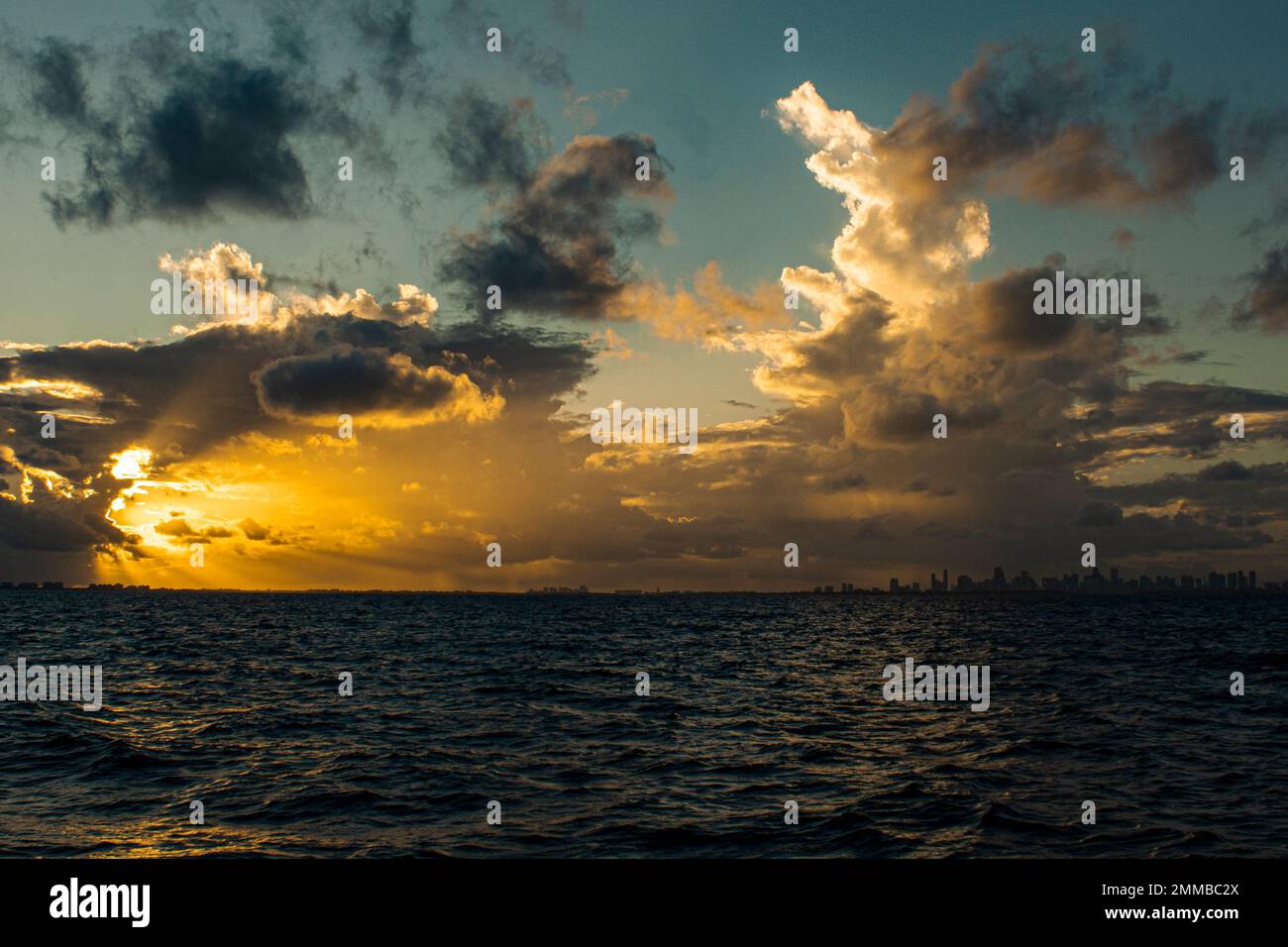 golden god rays over the Miami coast Stock Photo - Alamy