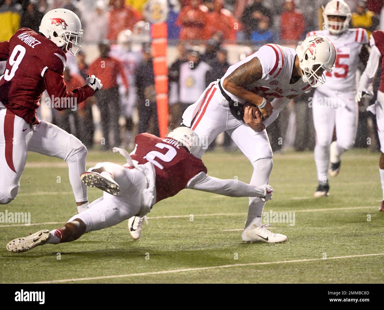 Mississippi quarterback Jordan Ta'amu slips past Arkansas defender ...