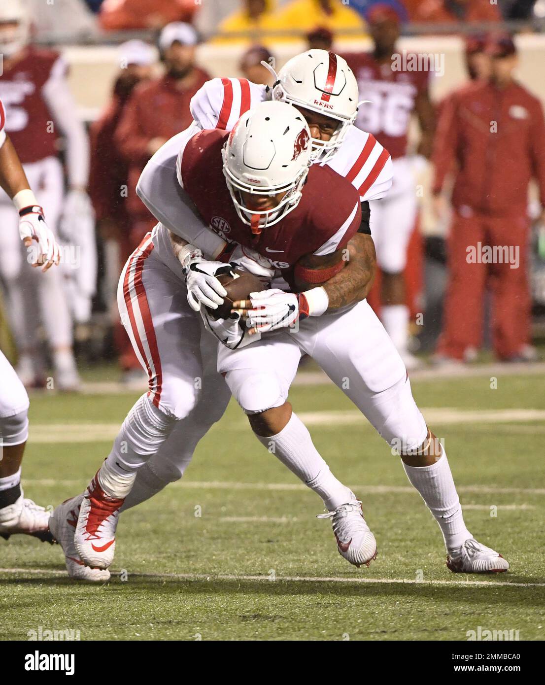 Mississippi defender Armani Linton tackles Arkansas running back Devwah ...