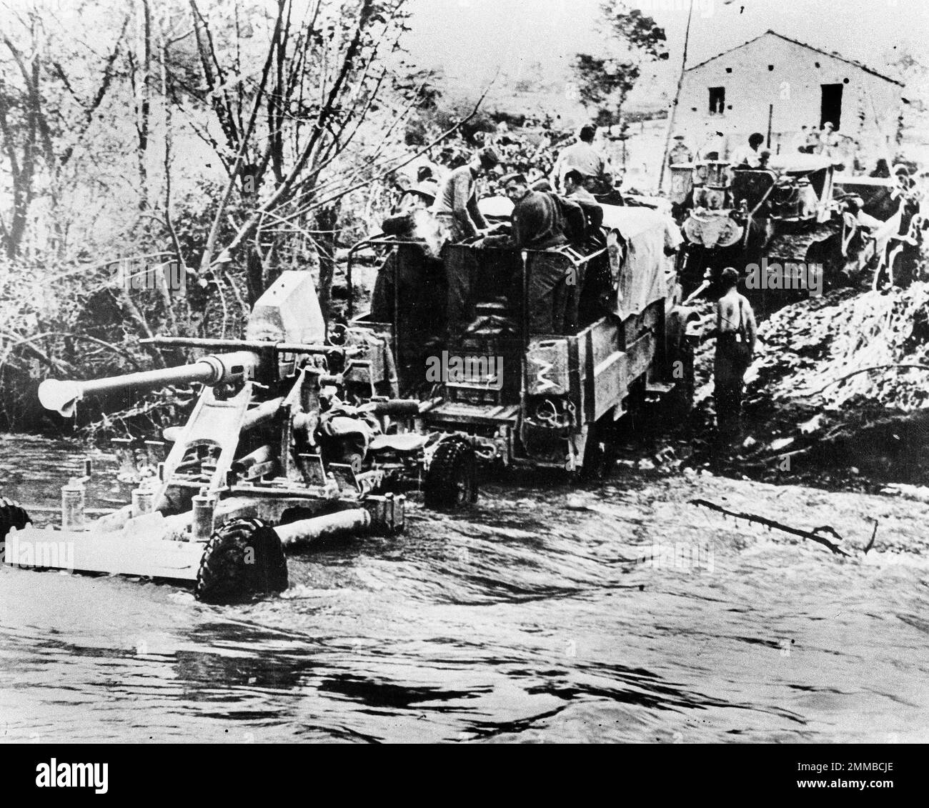 Canadian Army men fighting the Germans in Italy use a bulldozer to pull ...