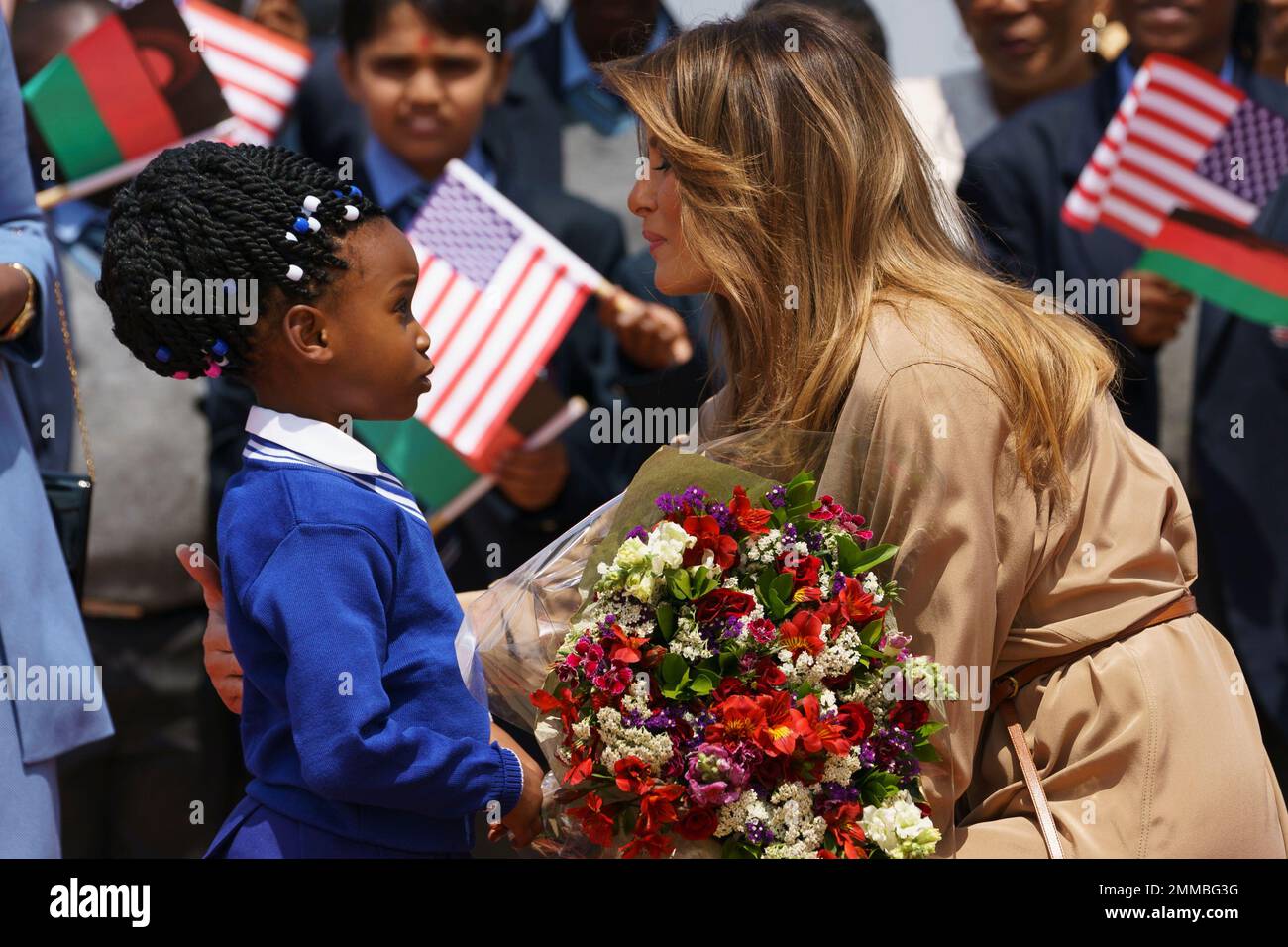 First lady Melania Trump is greeted by a flower girl as she arrives at ...