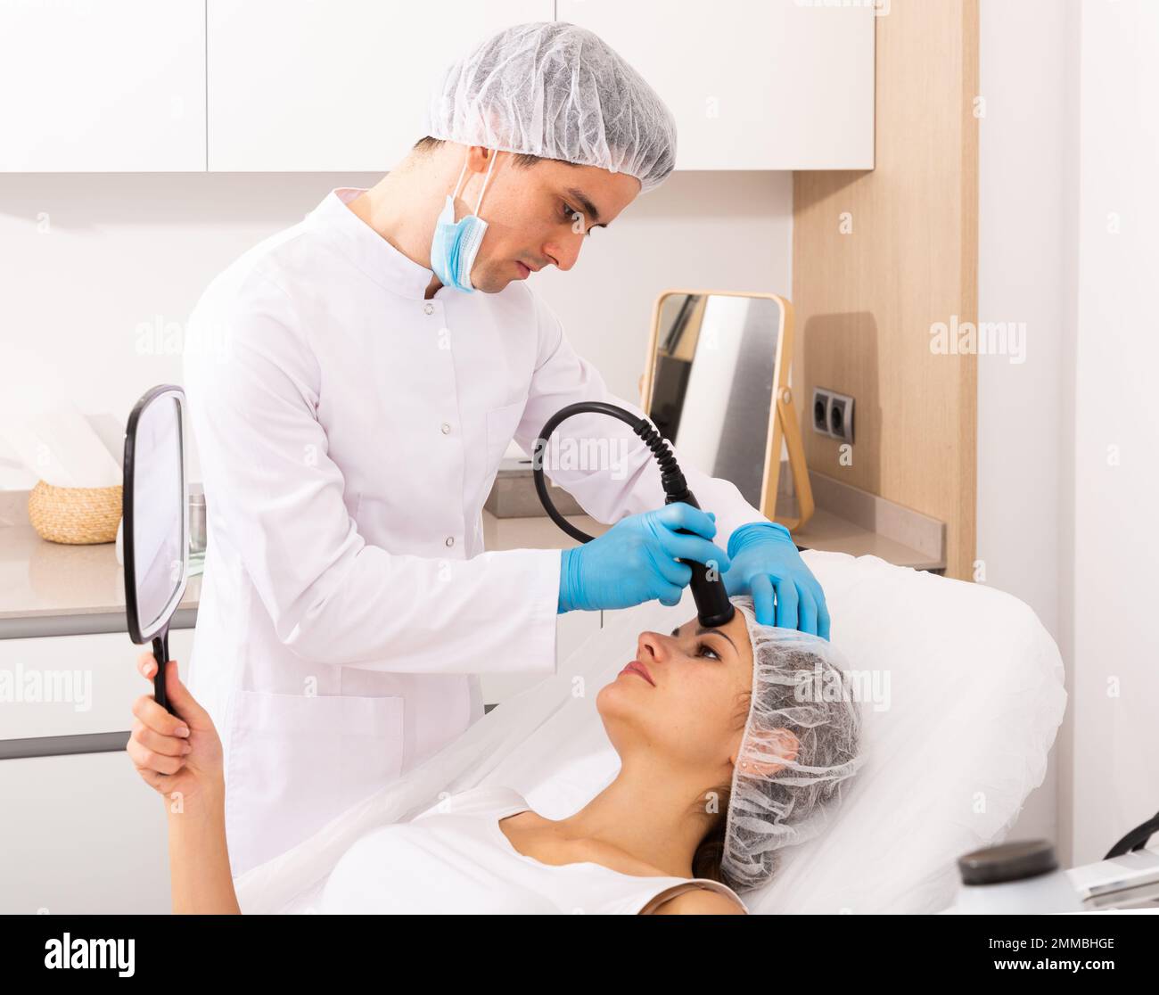 Woman getting face ultrasound lifting procedure Stock Photo - Alamy