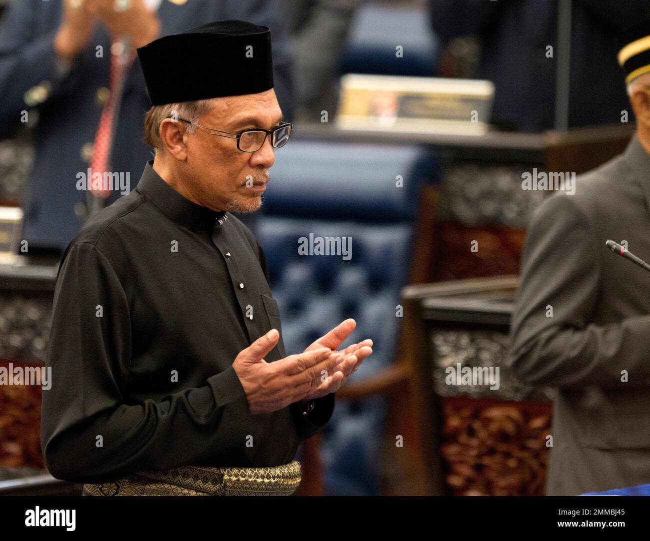 Malaysian politician Anwar Ibrahim prays during his swearing-in ...