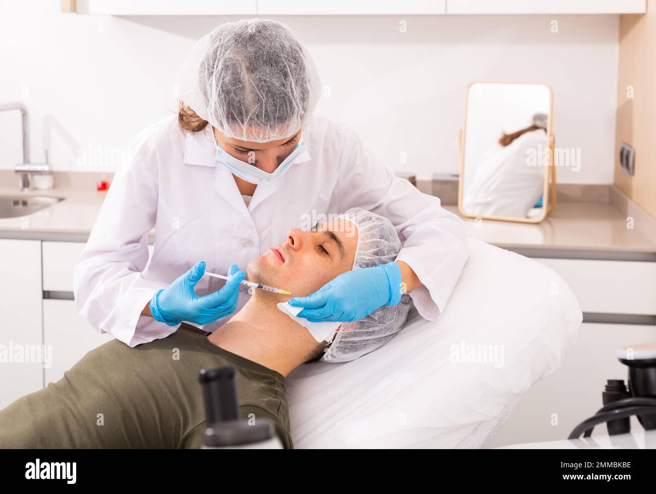 Man getting face injections at aesthetic clinic Stock Photo - Alamy