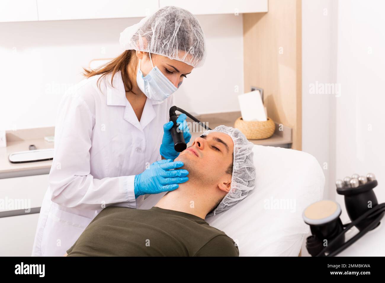 Man getting face ultrasound lifting procedure Stock Photo - Alamy