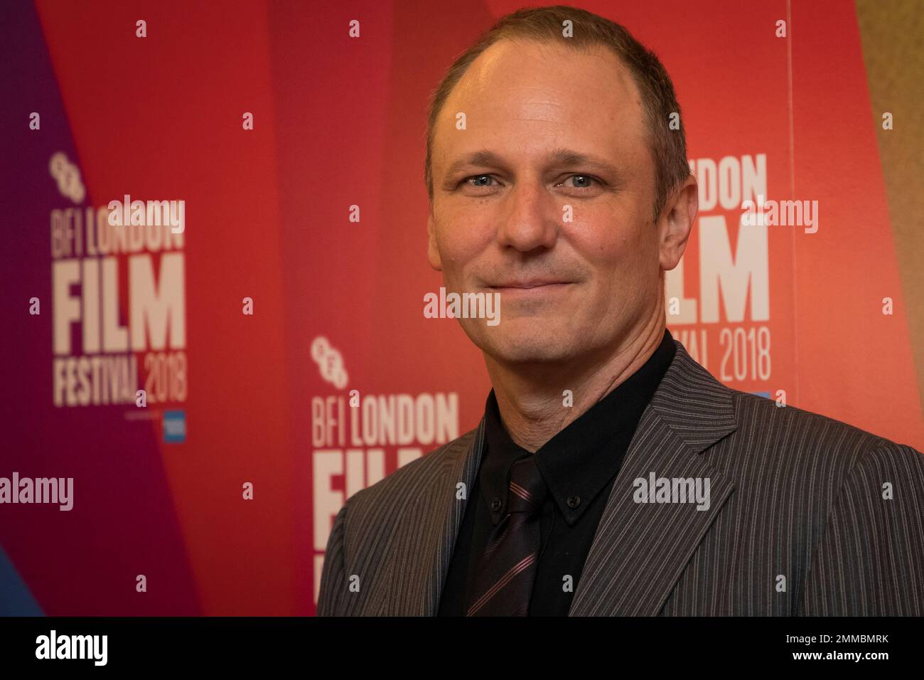Producer and screenwriter Phil Hay poses for photographers upon arrival ...
