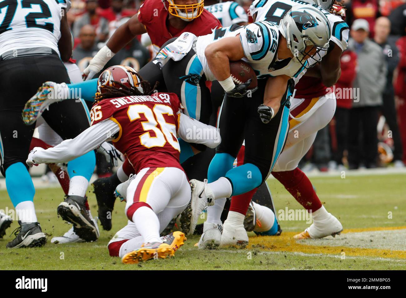 Carolina Panthers running back Christian McCaffrey (22) is upended by ...