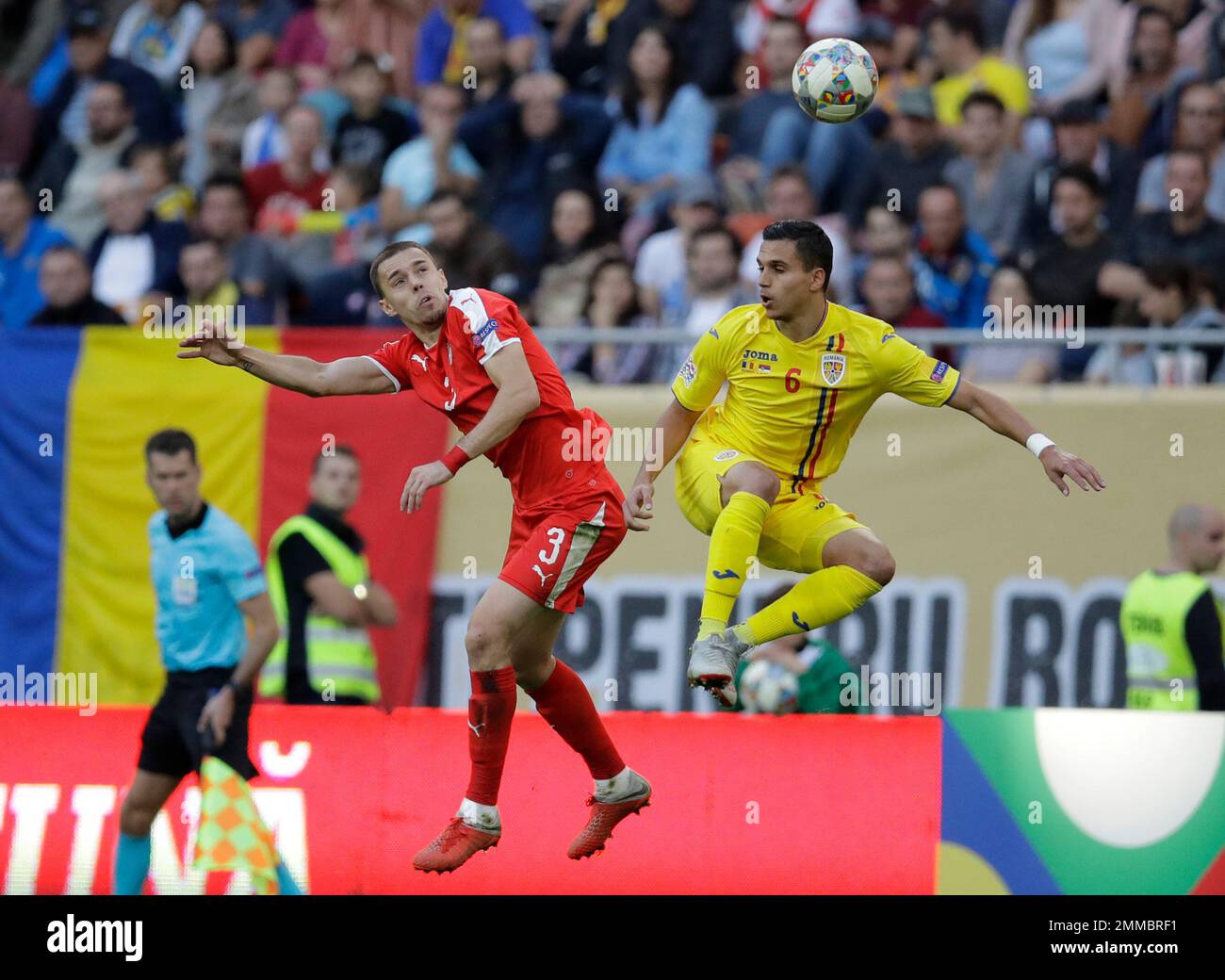Serbia's Milan Rodic, left, jumps for a header with Romania's Vlad ...