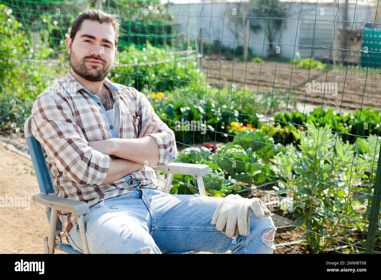 Male farmer sitting on fence hi-res stock photography and images - Alamy