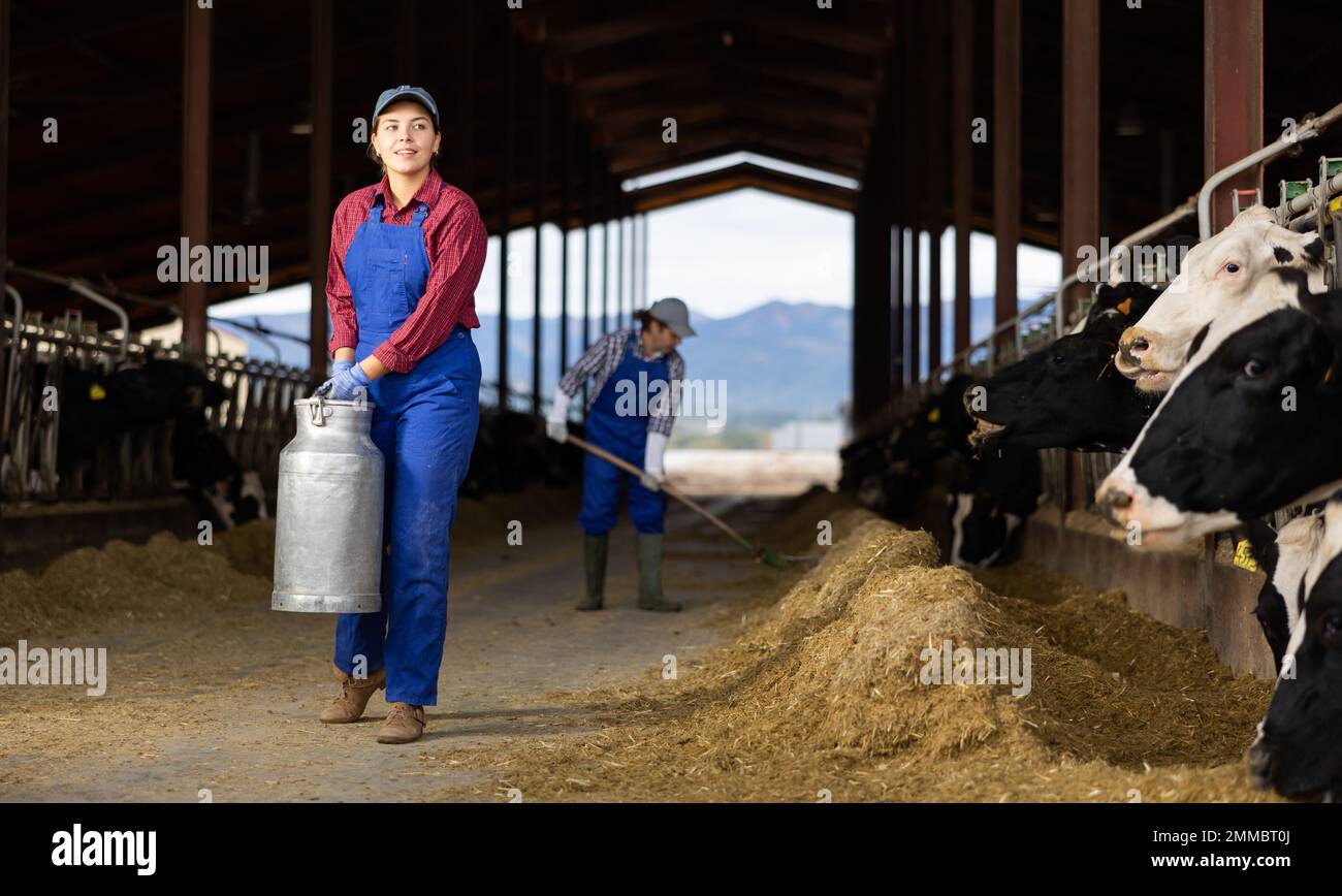 Farmer woman is holding can at cow farm Stock Photo - Alamy