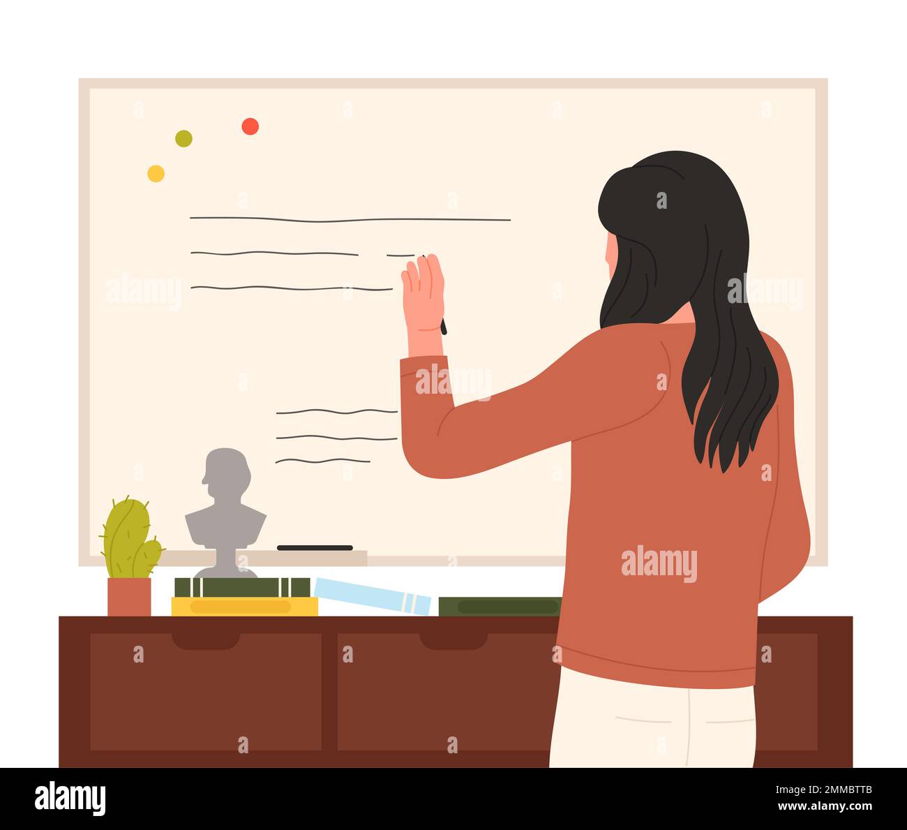 Back view teacher standing at blackboard in classroom writes with chalk ...