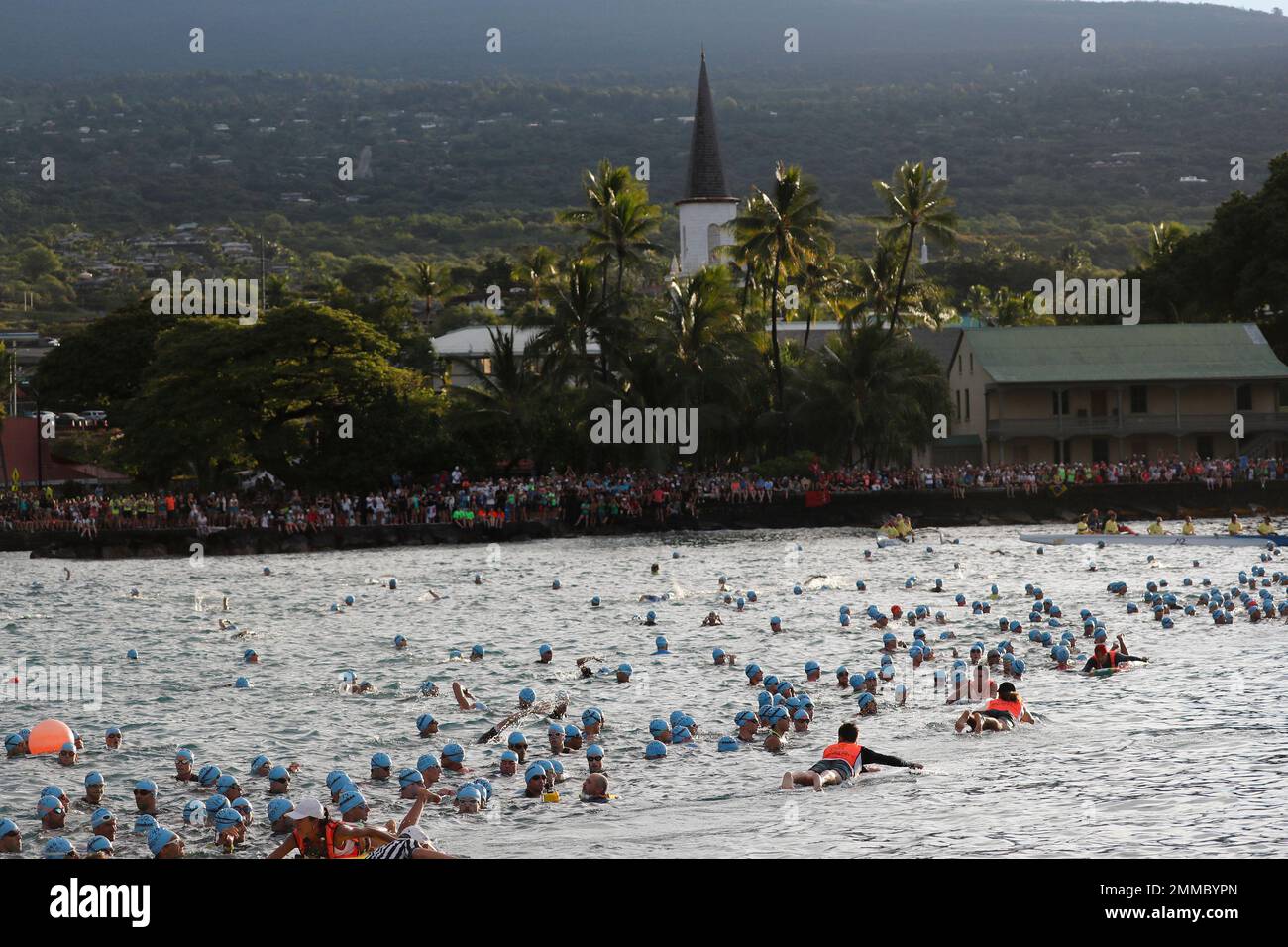 Men participants wait at the starting line before the swim race of the ...