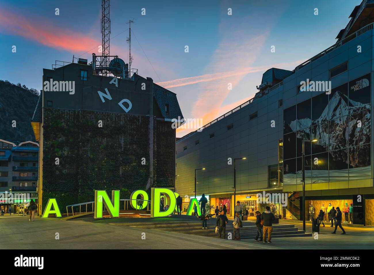 Andorra la Vella, Jan 2020 People watching iconic neon letters forming sign Andorra at night ...