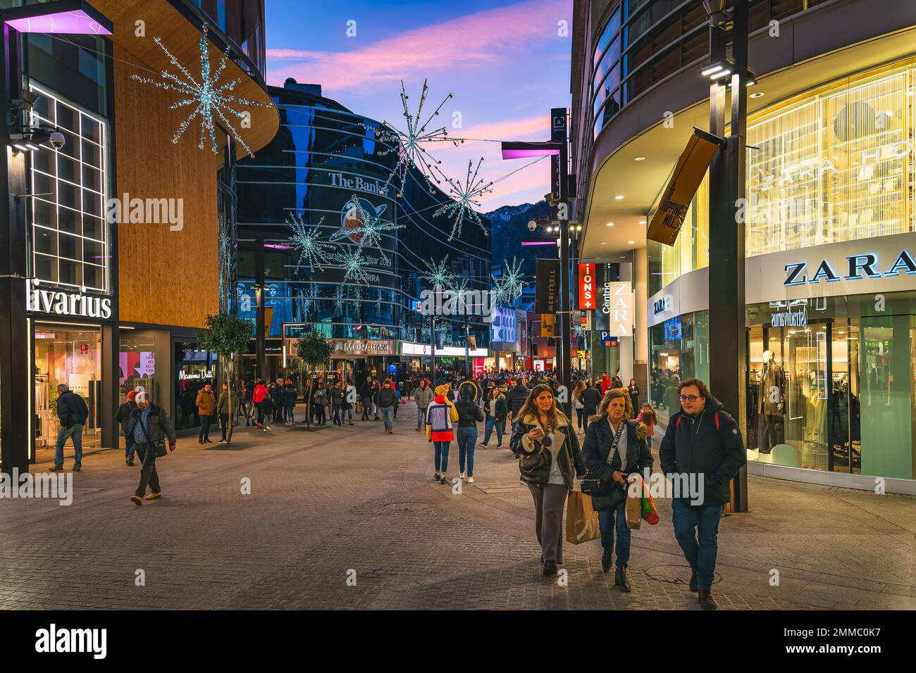 Andorra la Vella, Jan 2020 Crowd of people duty free shopping on street with modern shops and ...