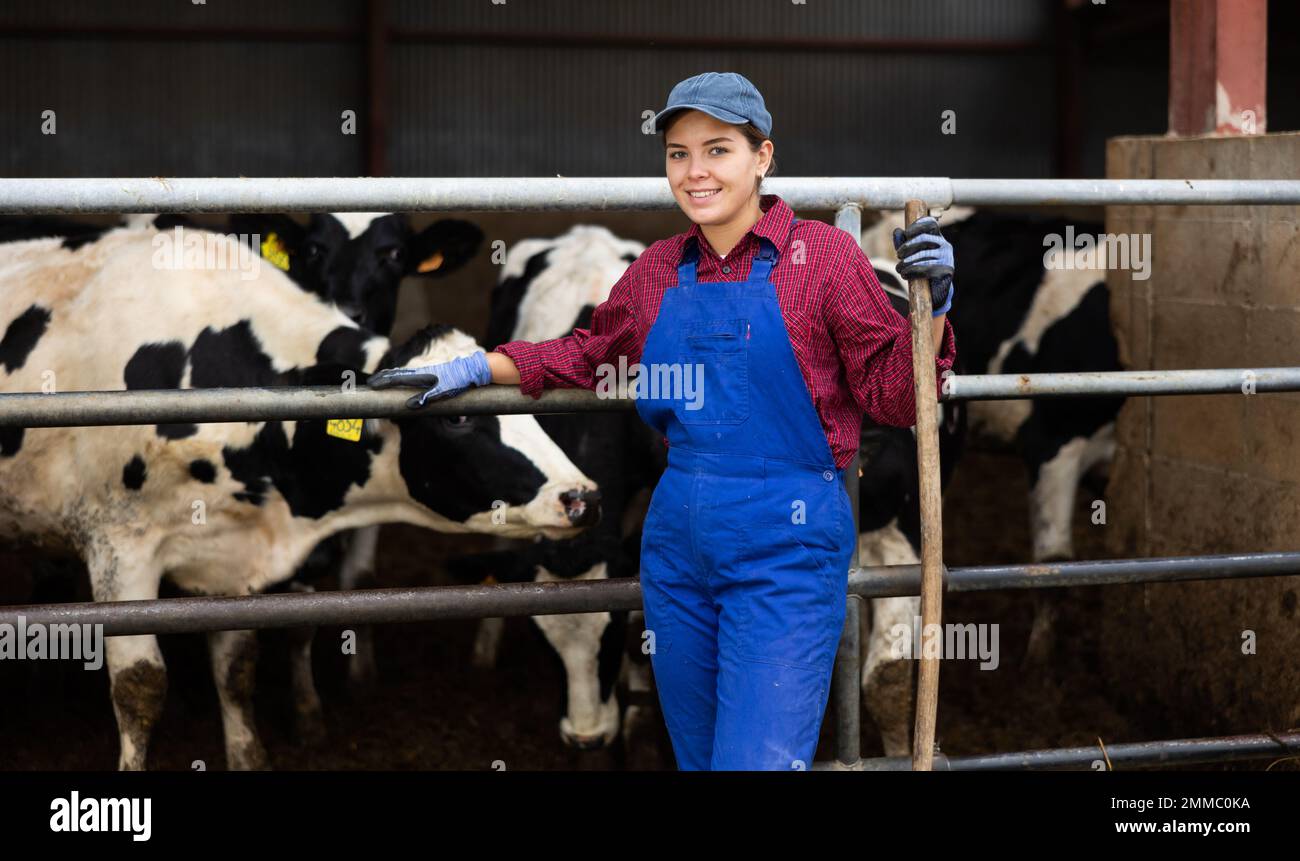 Farmer woman stands with rake at cow farm Stock Photo - Alamy