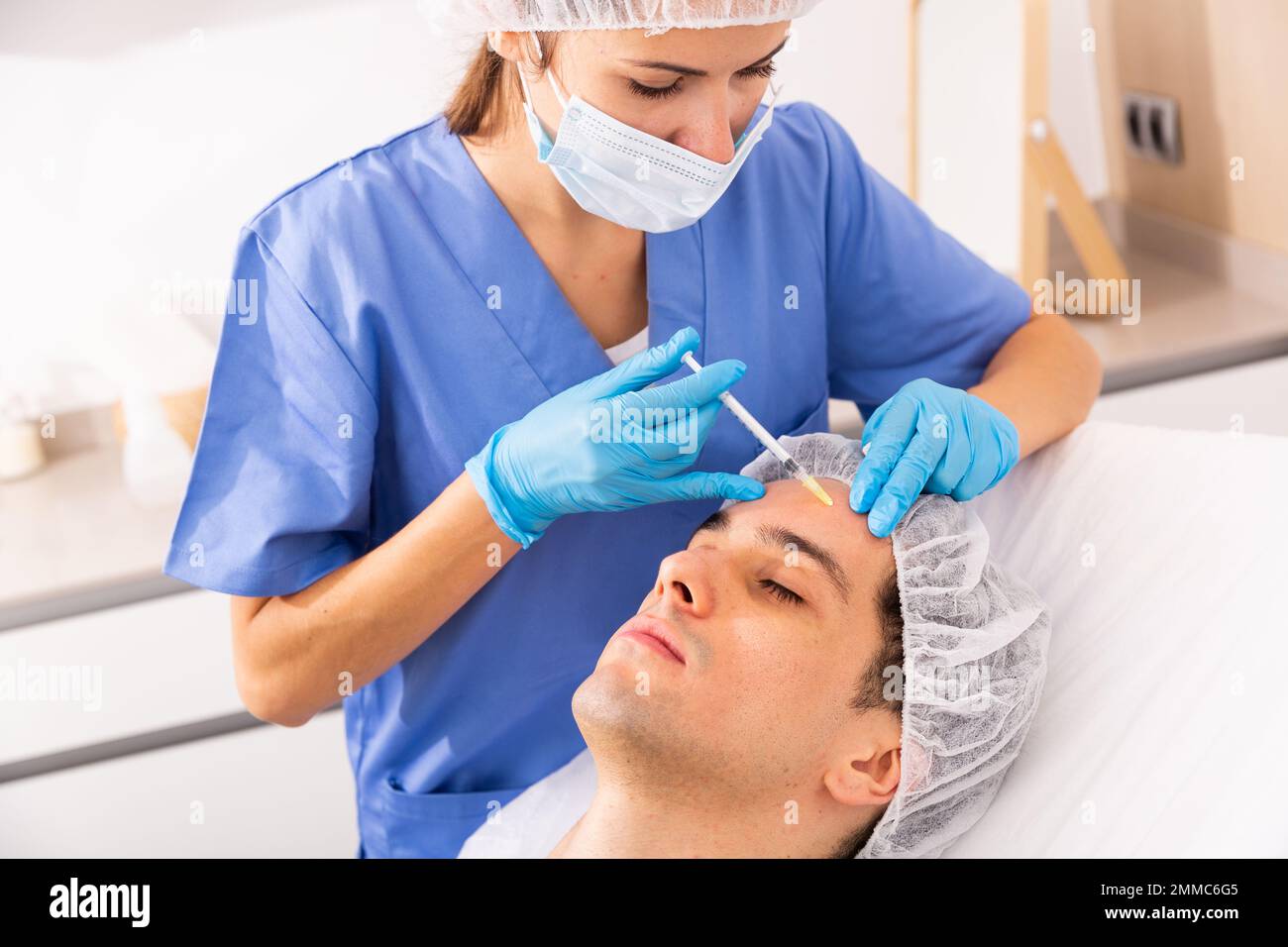 Man receiving facial contouring injections Stock Photo - Alamy