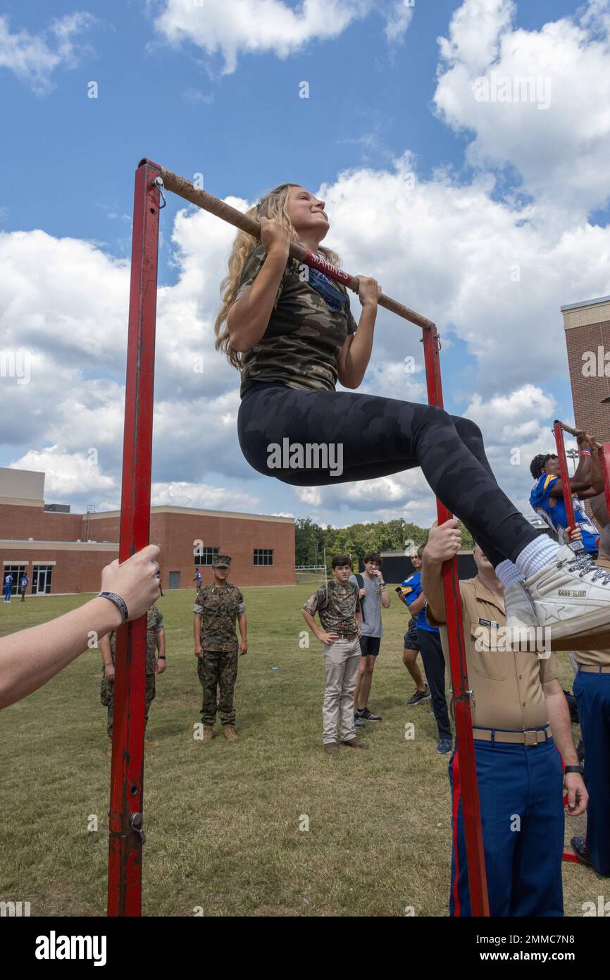 An Oxford High School cheerleader performs pull-ups to contribute to ...