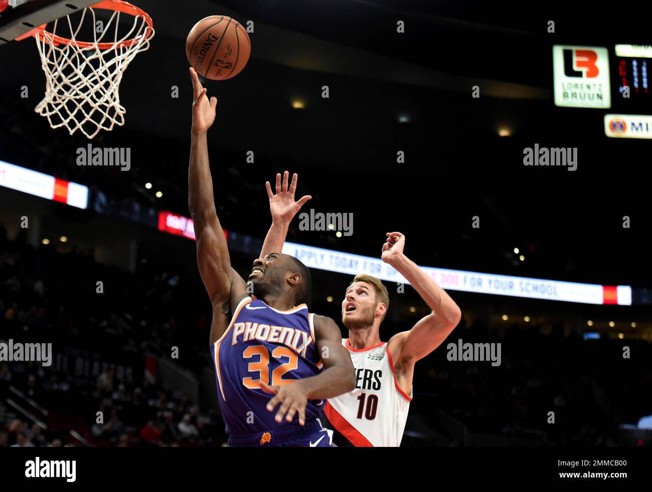 Phoenix Suns guard Davon Reed, left, drives to the basket past Portland ...