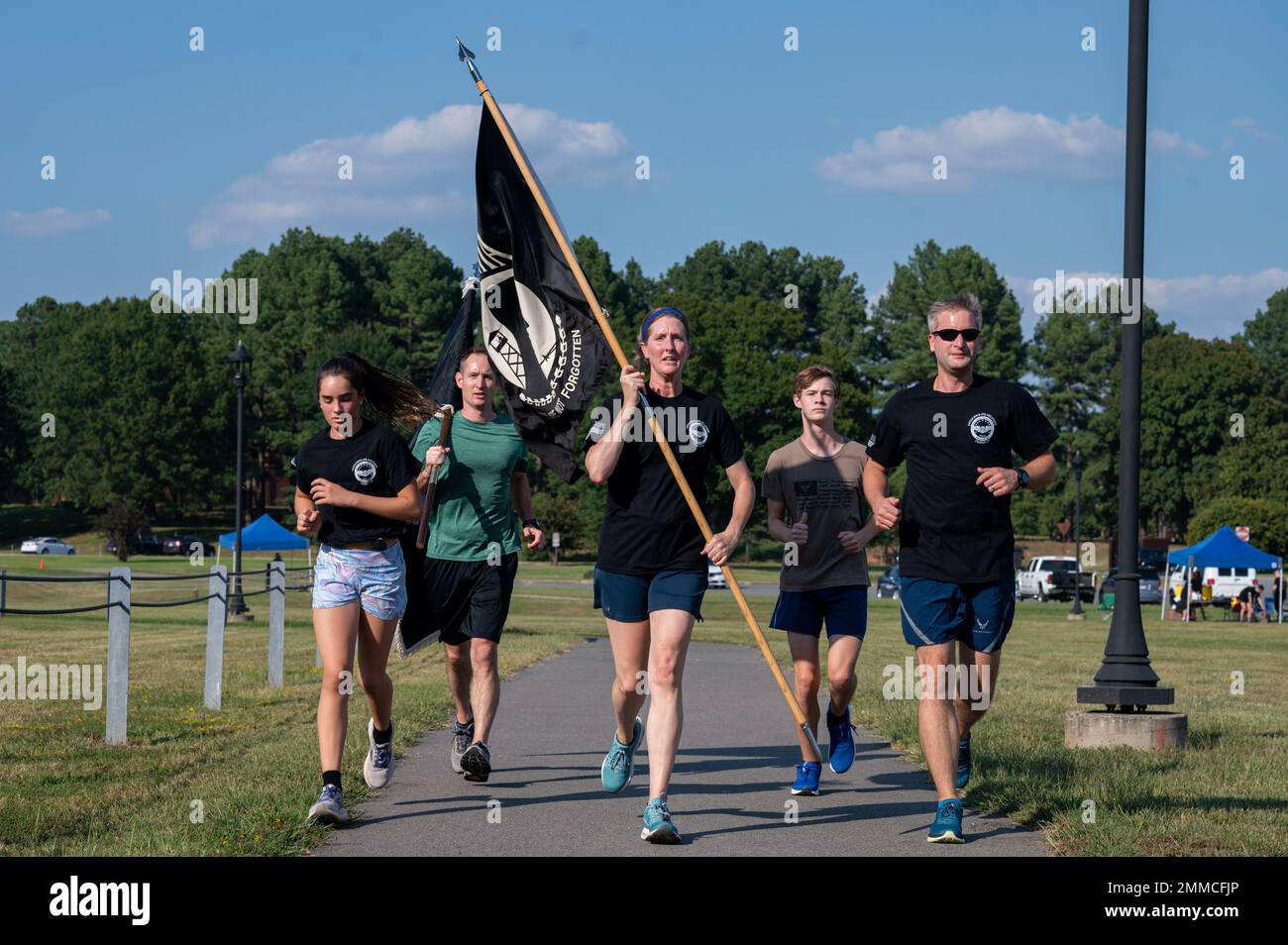 Col. Angela Ochoa, 19th Airlift Wing commander, carries a POW/MIA flag ...