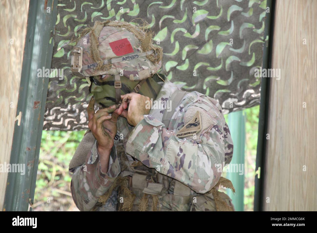 EFMB Candidate applies camouflage during the Warrior Skills testing ...