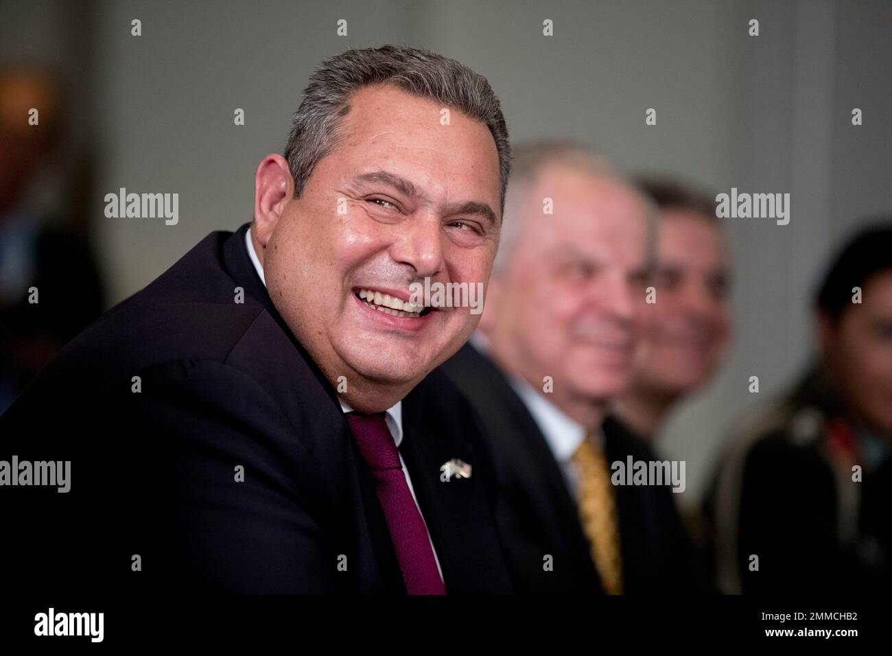 Greek Defense Minister Panagiotis Kammenos smiles during a meeting with ...