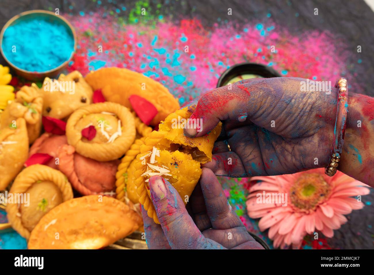 Hands Of A Girl Painted With Colorful Gulal Holding Delicious Gujiya ...