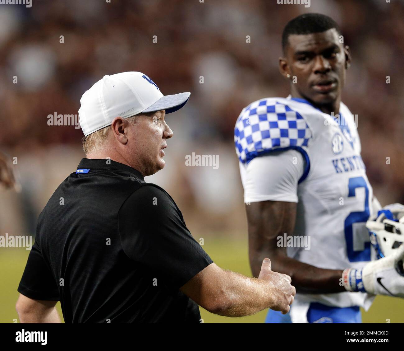 Kentucky head coach Mark Stoops talks with wide receiver Dorian Baker ...