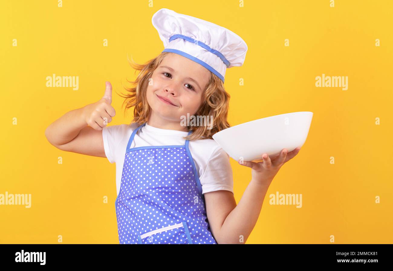 Funny kid chef cook with kitchen plate, studio portrait. Child chef ...