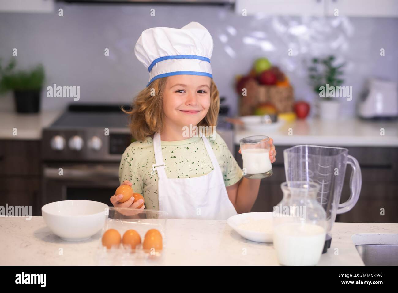 Funny kid with eggs at kitchen. Children cooking in the kitchen. Funny ...