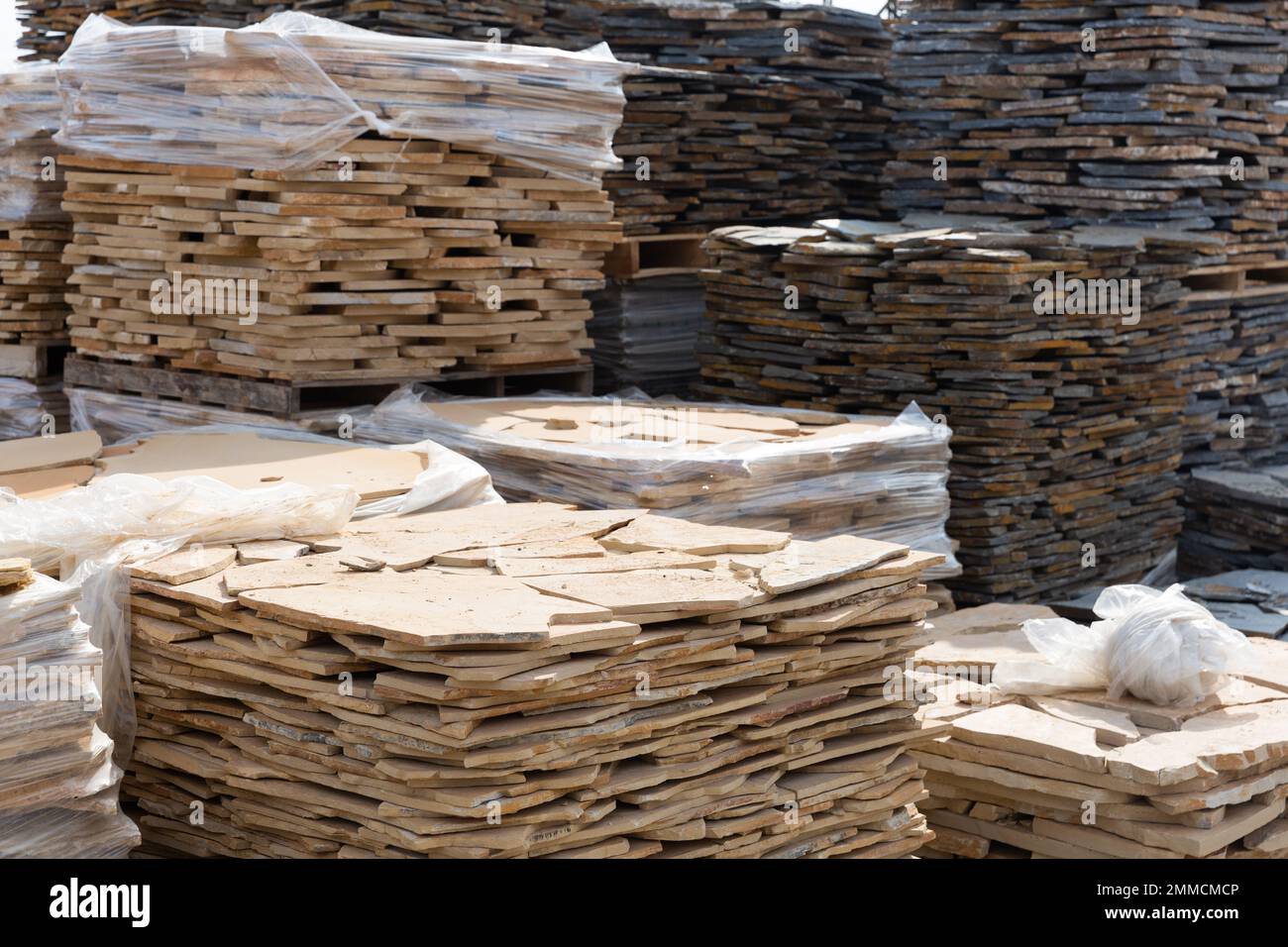 Natural stone blocks packed in stacks at a hardware store warehouse ...