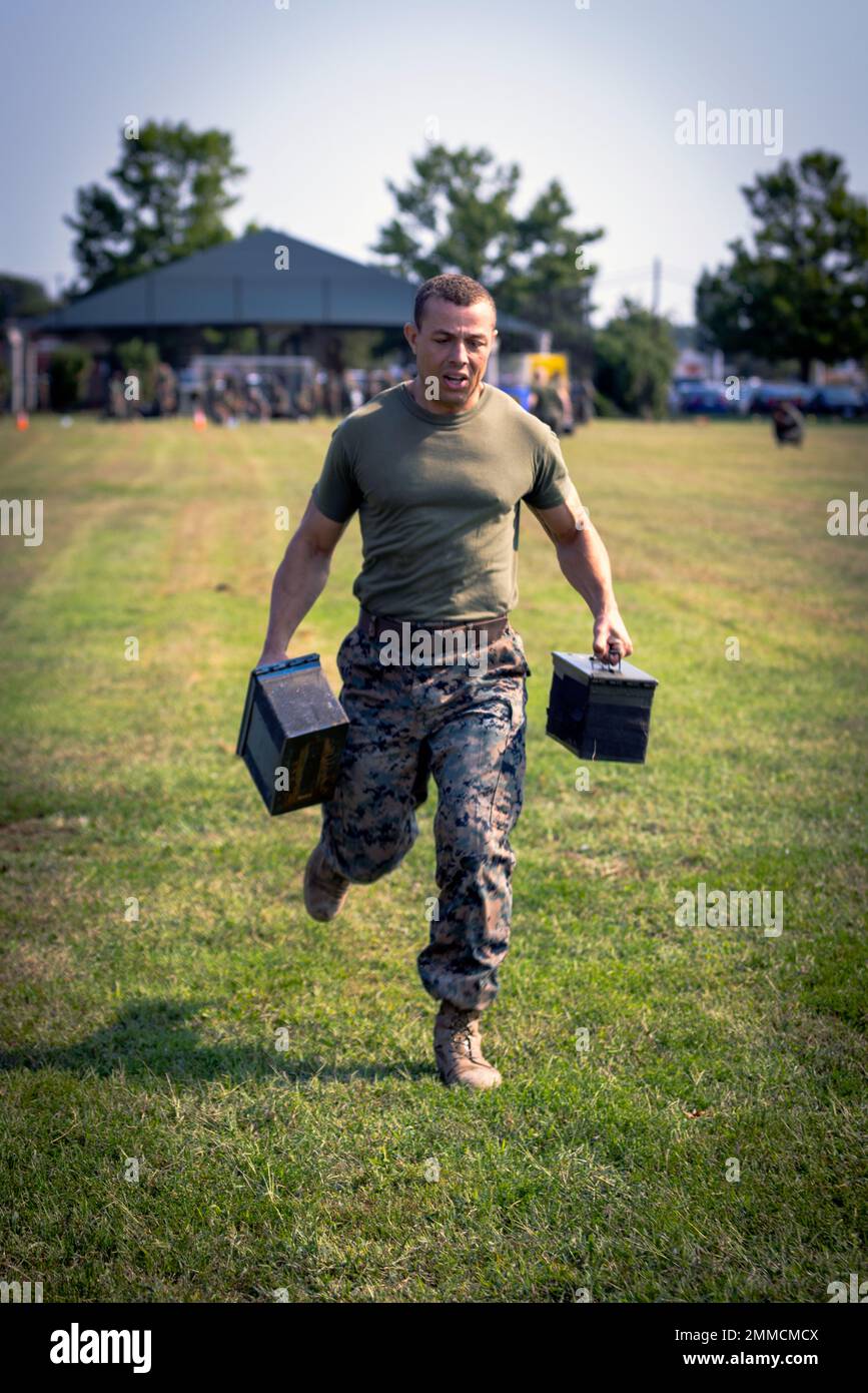 U.S. Marine Corps Sgt. Dertique Mines, competes in an ammo can relay ...