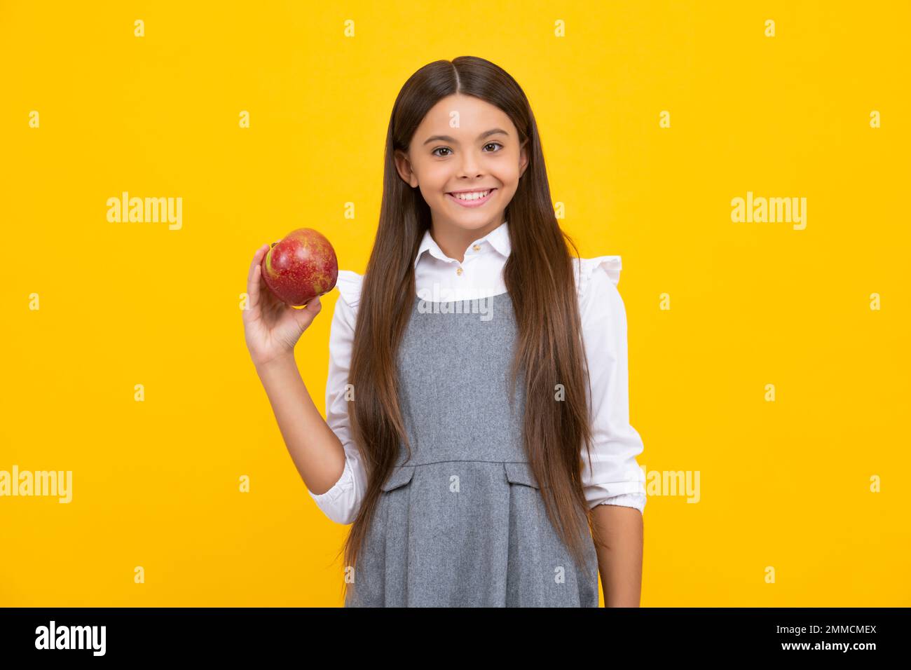 Teenager child with apple on yellow isolated background. apples are ...