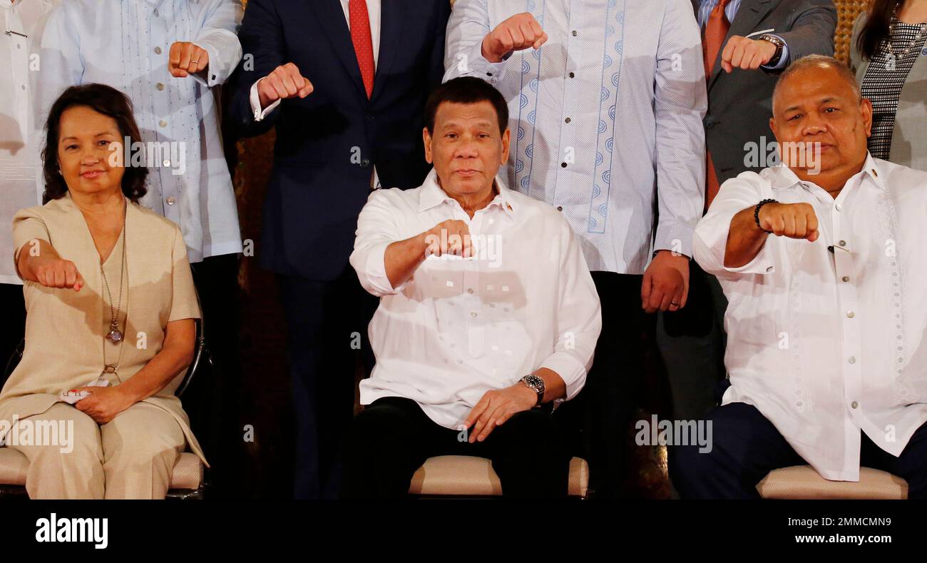 Philippine President Rodrigo Duterte gestures with a fist bump after ...