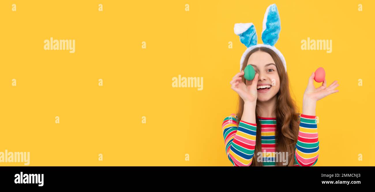 happy easter. childhood happiness. child in rabbit ears hold painted ...