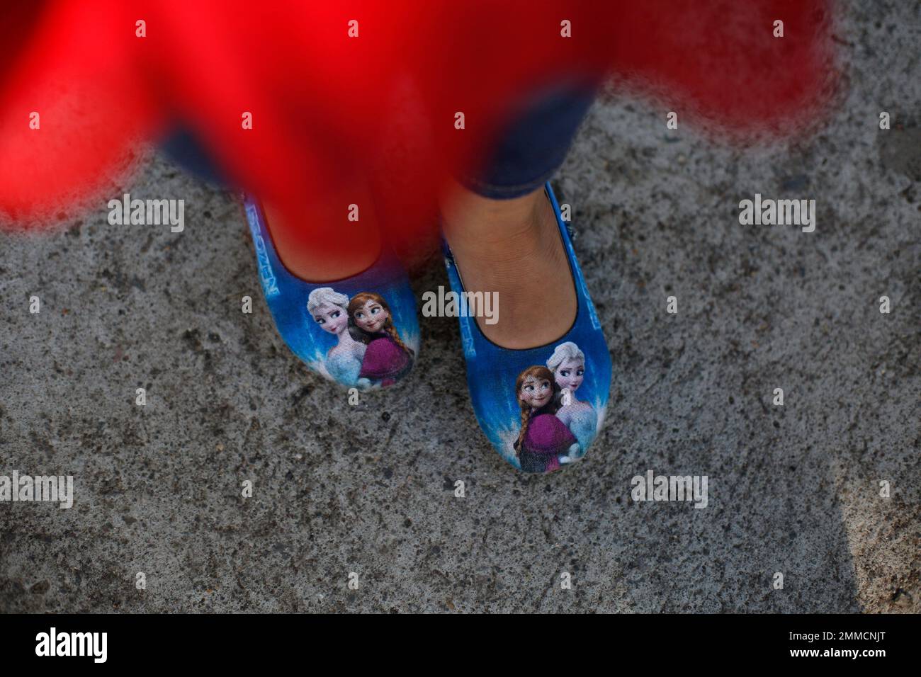 Five-year-old Alexa wears shoes depicting characters from Disney's ...