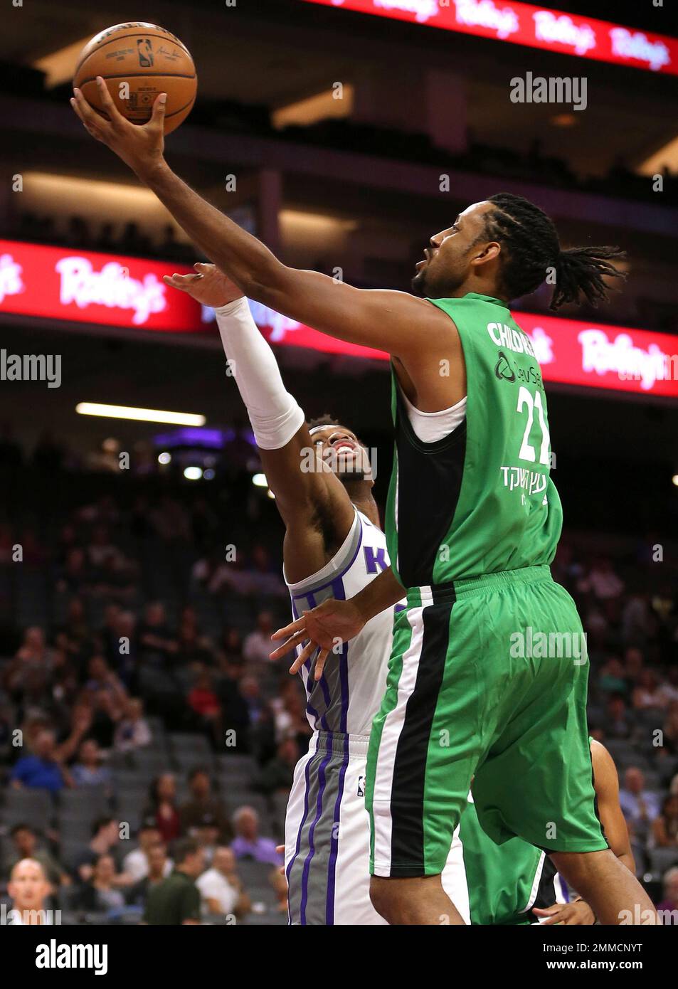 Maccabi Haifa forward Josh Childress, right, goes to the basket against ...