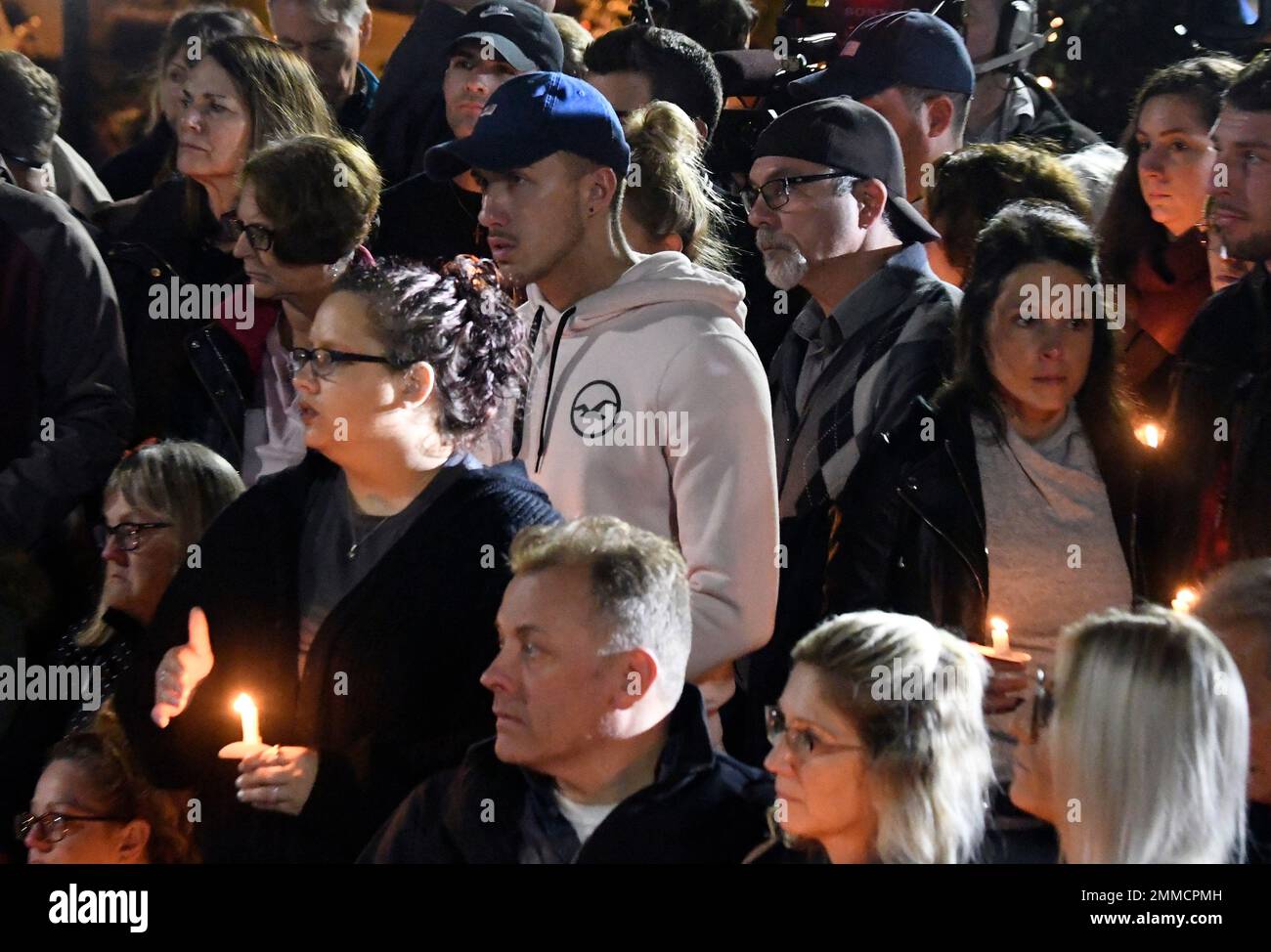 Family members and friends gather for a candlelight vigil memorial at ...