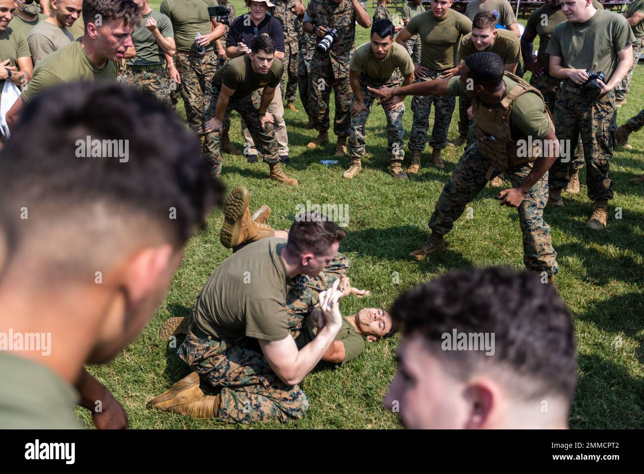 U.S. Marine Corps Cpl. Kendrick Schumacher, top, competes in a ...