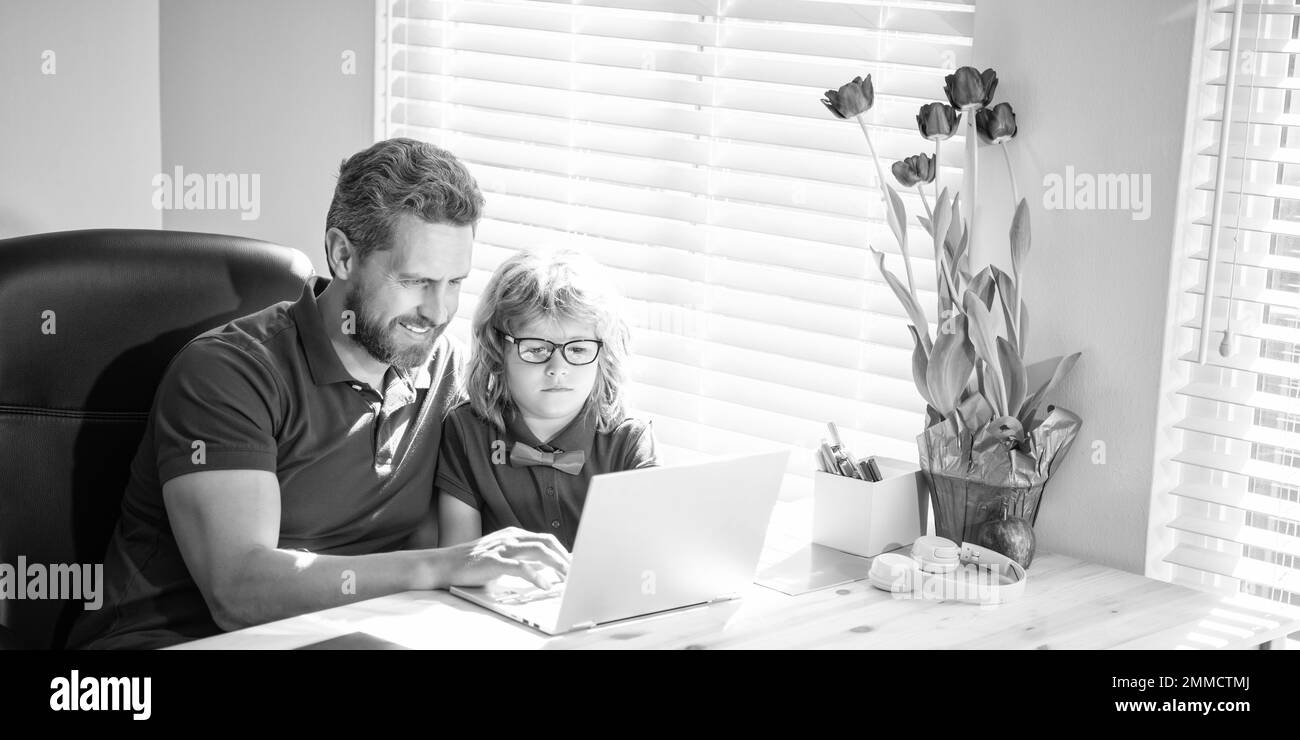 happy dad helping his school son child in glasses study with computer ...