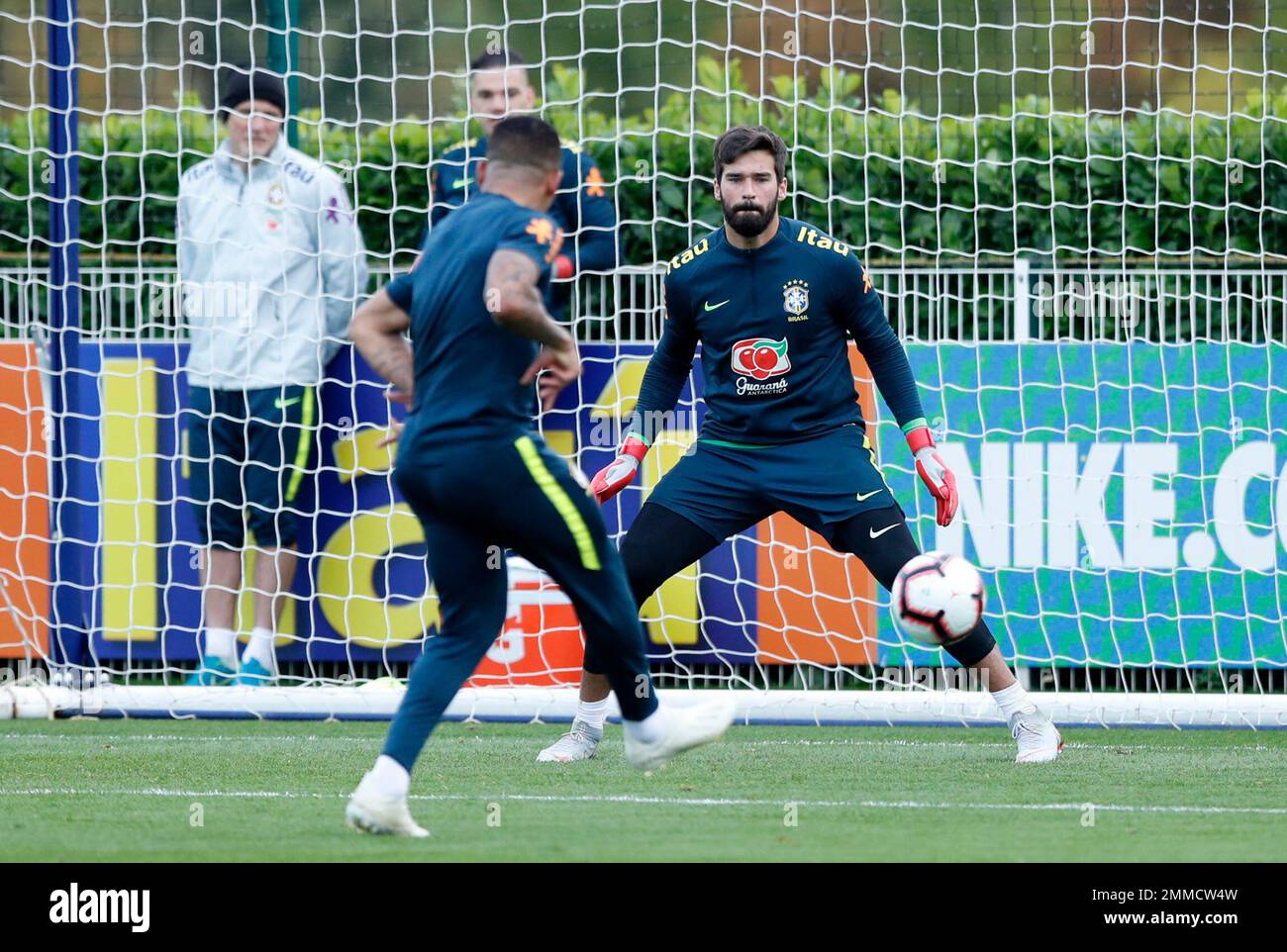 Brazil's goalkeeper Alisson attempts to save a shot as he takes part in ...