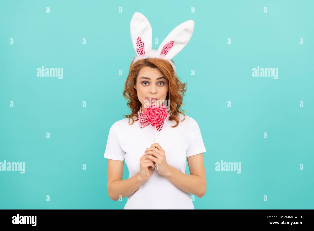 funny easter woman wear bunny ears hold heart lollipop Stock Photo - Alamy
