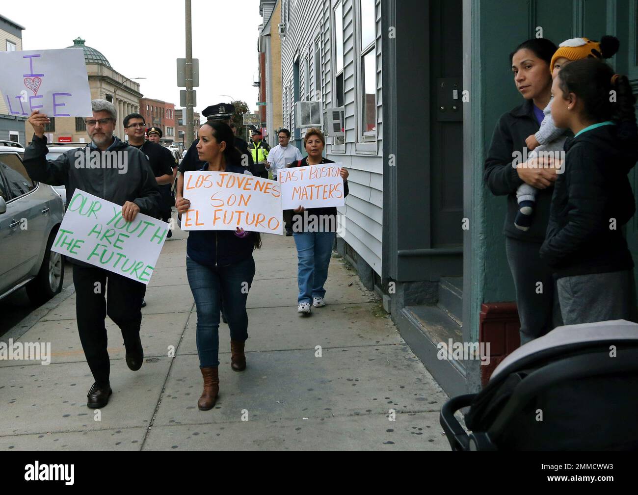 In this Sept. 20, 2018 photo, East Boston residents watch as Pastor ...