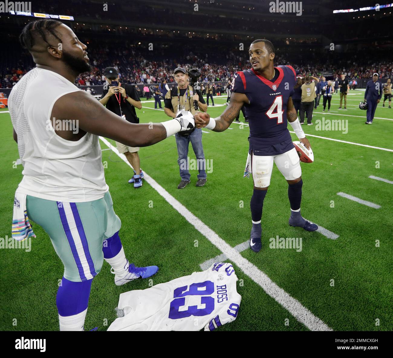 Dallas Cowboys defensive tackle Daniel Ross, left, and Houston Texans ...