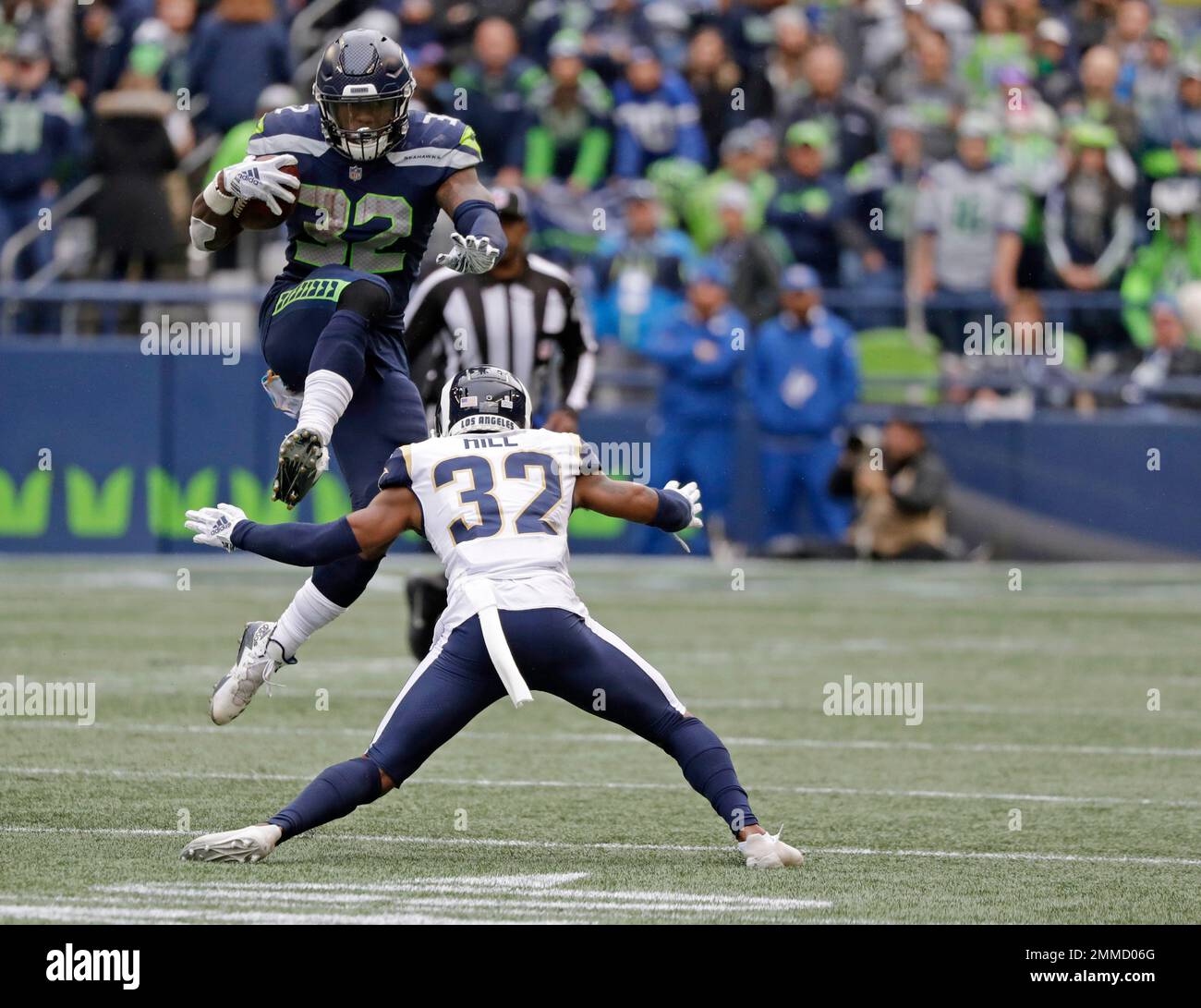 Seattle Seahawks running back Chris Carson, left, leaps over Los ...
