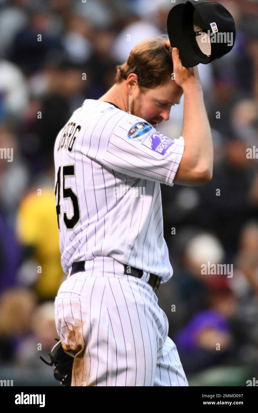 Colorado Rockies relief pitcher Scott Oberg reacts after throwing a ...