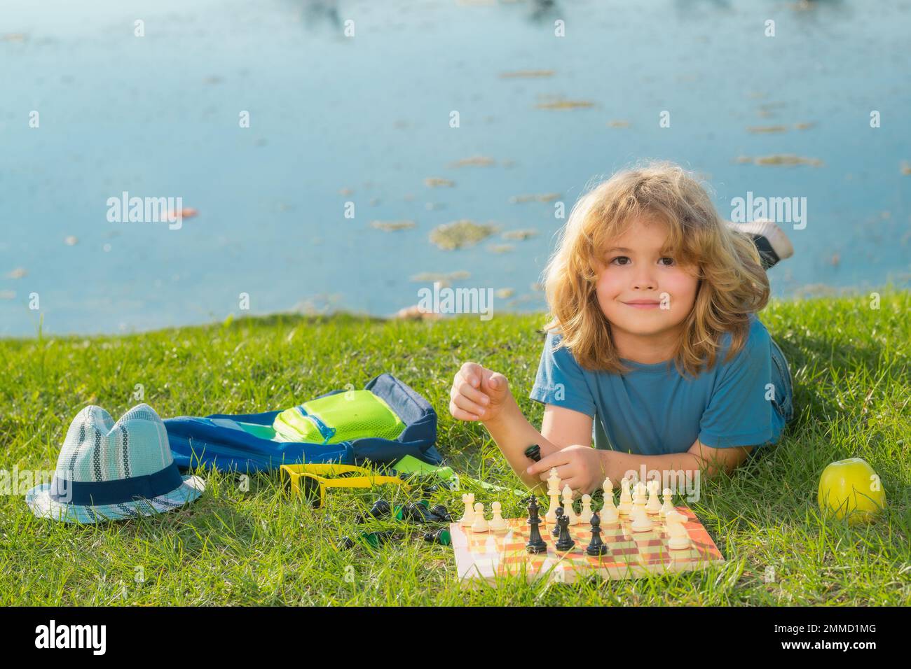 Child playing chess. Clever kid thinking about chess Stock Photo - Alamy