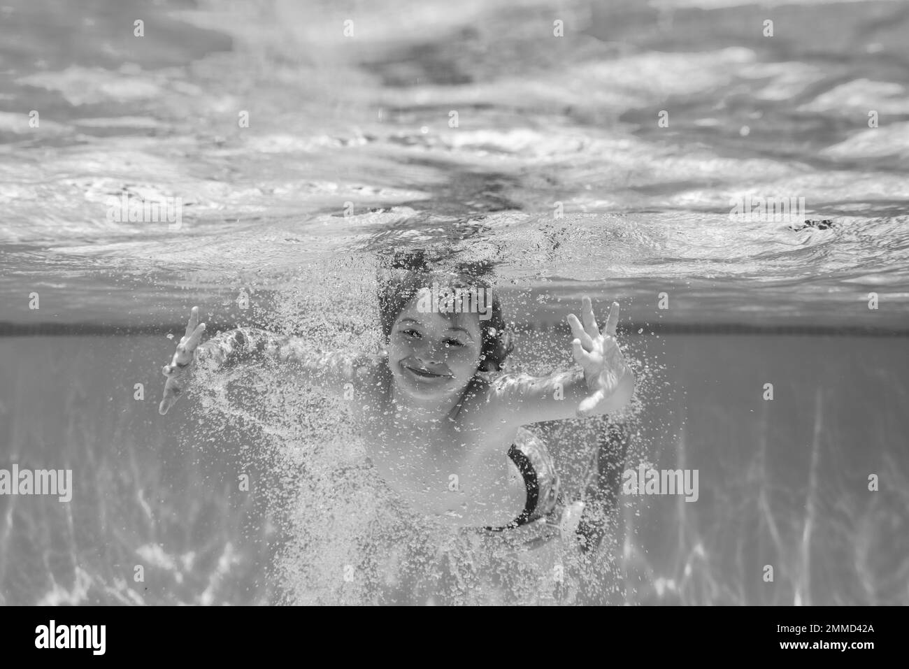 Underwater child in the swimming pool. Cute kid boy swimming in pool ... Underwater child in the swimming pool. Cute kid boy swimming in pool ...